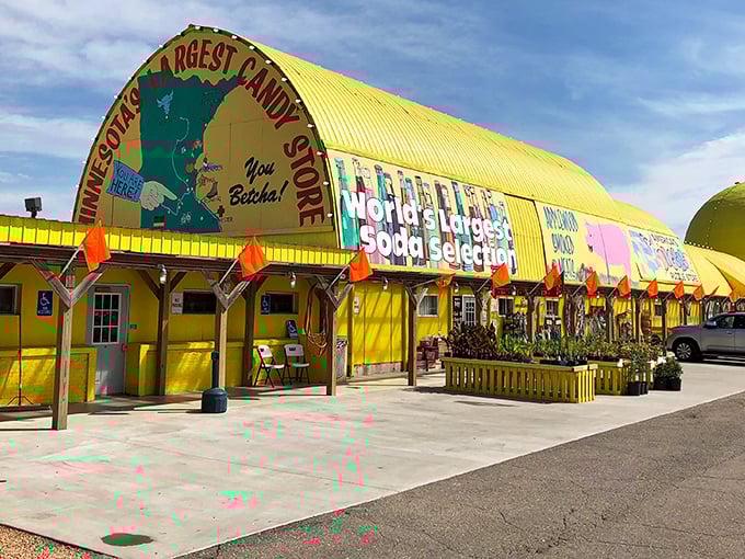 The sunshine-yellow exterior of Minnesota's Largest Candy Store stands like a beacon of sweetness along Highway 169, promising sugar-fueled adventures within.