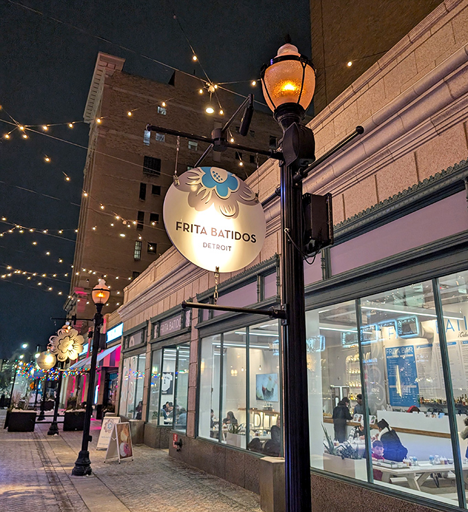 Nighttime magic at Frita Batidos, where string lights and that iconic blue flower sign beckon hungry travelers into a Cuban-inspired oasis in downtown Detroit.
