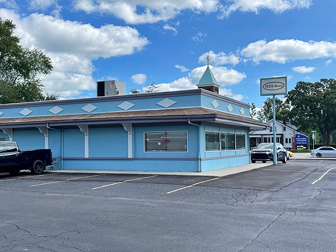 The cheerful blue exterior of M29 Diner stands like a beacon of comfort food promise along Dixie Highway.