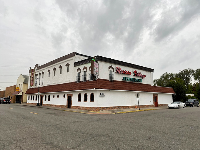 The iconic white exterior of Mexican Village Restaurant stands proudly at the corner of Bagley and 18th, a Detroit landmark hiding culinary treasures within.