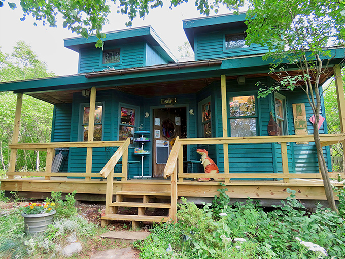 The teal cottage exterior beckons with nostalgic charm, its wooden porch and steps inviting visitors into a world where childhood memories come alive.