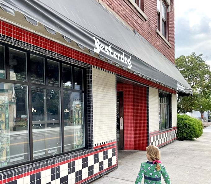 Yesterdog's iconic red and white tiled exterior stands as a beacon of nostalgia in Grand Rapids, inviting hot dog enthusiasts through its timeless doorway.