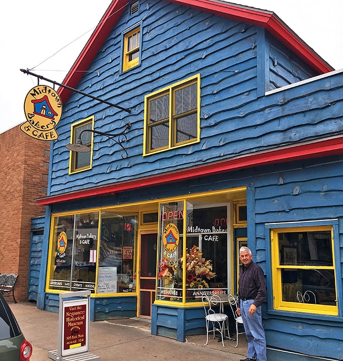 The vibrant blue exterior with sunny yellow trim makes Midtown Bakery & Cafe an unmissable landmark in Negaunee, promising sweet adventures within.