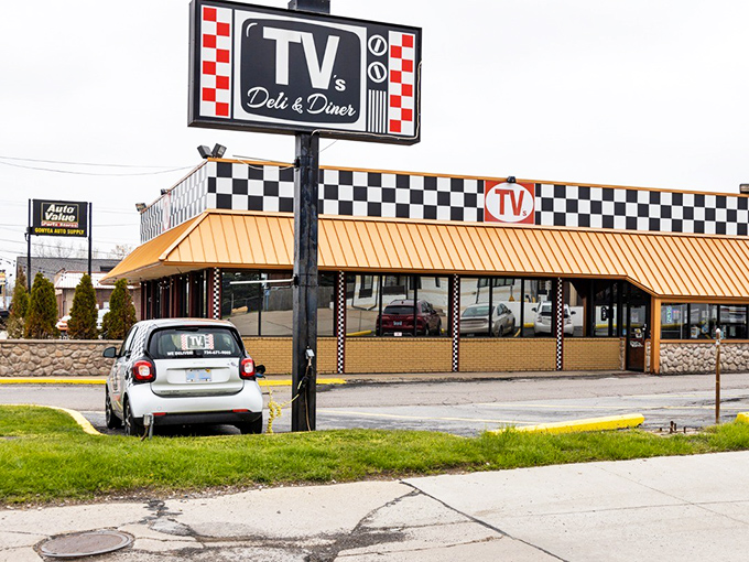 The iconic checkerboard sign of TV's Deli & Diner stands proud against the Michigan sky, promising retro delights and comfort food classics inside.