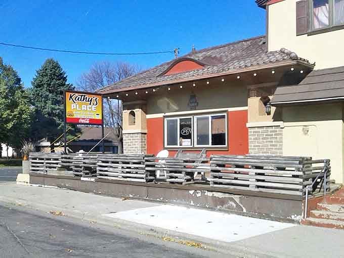 Kathy's Place welcomes hungry travelers with its charming exterior – a red-accented building promising homestyle comfort that delivers beyond expectations.