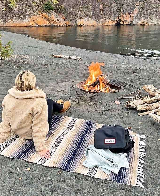 Primal elements unite: Fire and water meet on the black sand shore, creating the perfect setting for lakeside storytelling.