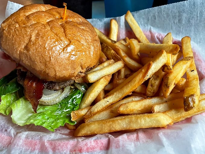 Simple perfection on a plate – a classic burger with hand-cut fries that reminds us why some culinary traditions never need updating.