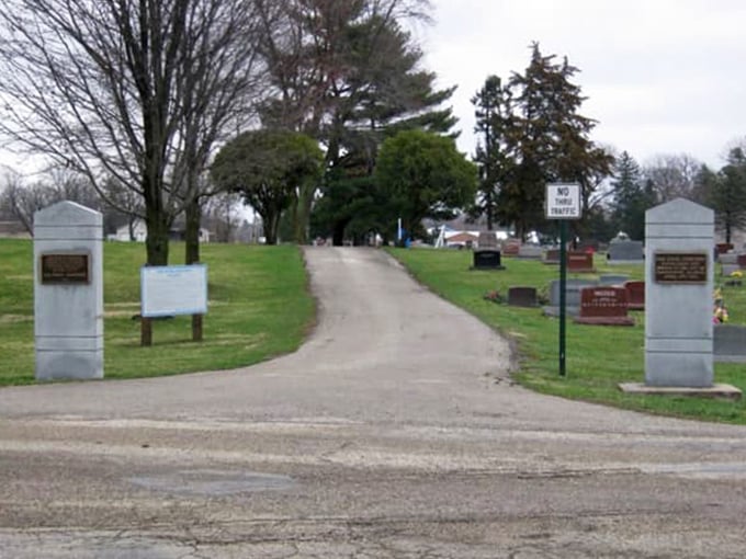 Twin pillars mark the entrance to this historic resting place, where Michigan's past is preserved in stone and memory.