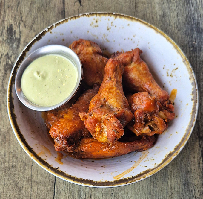 These wings aren't flying anywhere except straight to your taste buds, their crispy exterior giving way to tender meat that practically swims in flavor.