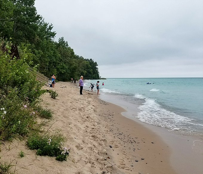 Family memories in the making – Christmas Cove's gentle waves welcome swimmers of all ages to Michigan's hidden gem.