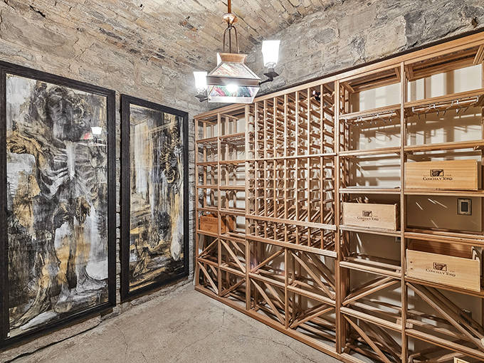 Wine enthusiasts rejoice at this custom cellar, where wooden racks cradle bottles beneath rustic stone ceilings that maintain perfect temperature naturally.