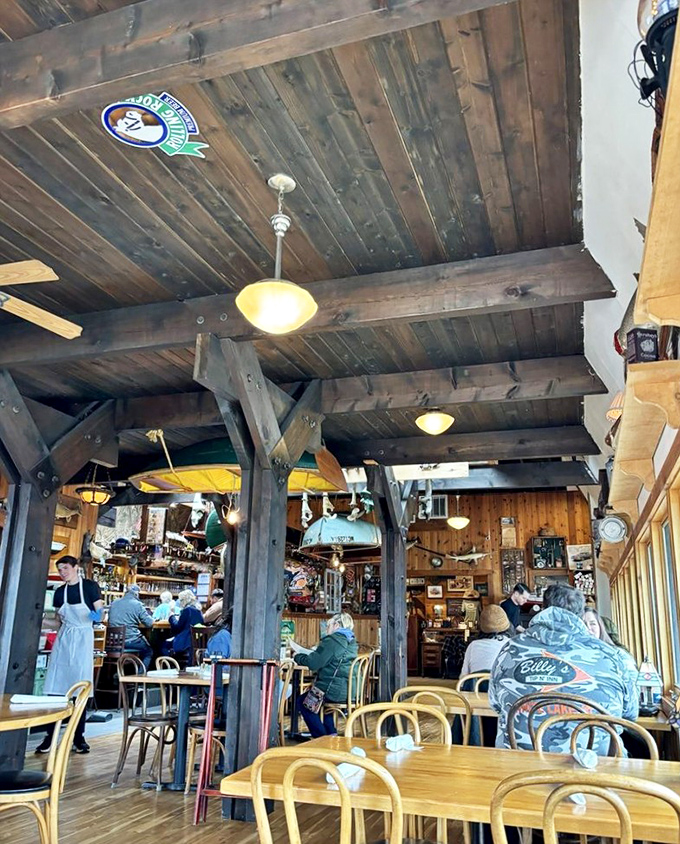 Rustic wooden beams frame happy diners enjoying the authentic atmosphere, where generations of families have created memories over exceptional meals.