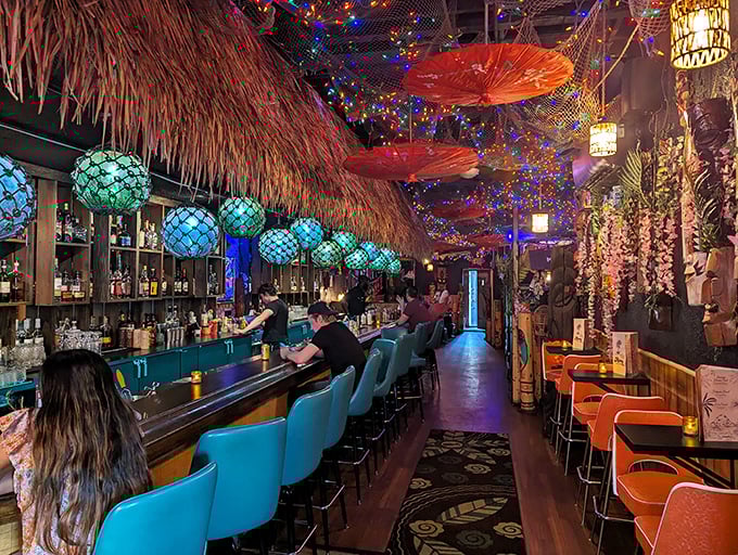 The bar's blue chairs invite patrons to settle in for an evening where time slows down and worries dissolve like sugar in rum.