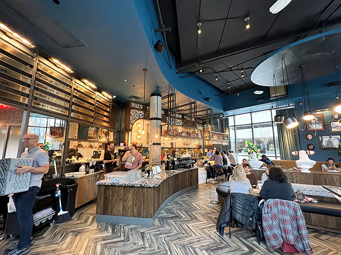 Morning light streams through windows as patrons settle in with laptops and lattes, finding comfort in this stylish downtown refuge.