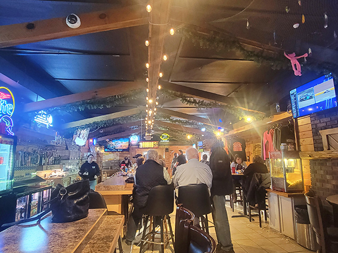 The evening crowd settles in at the bar, where conversations flow as freely as the beverages in this community gathering spot. 