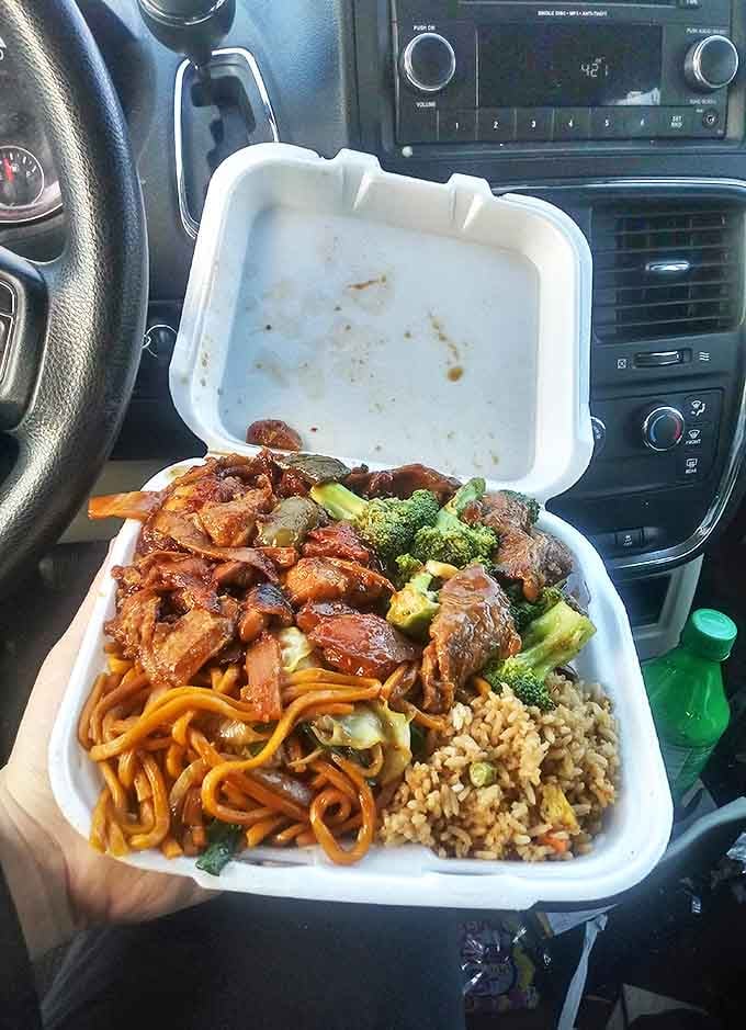Car dining at its finest &ndash; who needs a fancy table when your dashboard works perfectly? The true test of takeout: it's so good you can't even wait to get home!