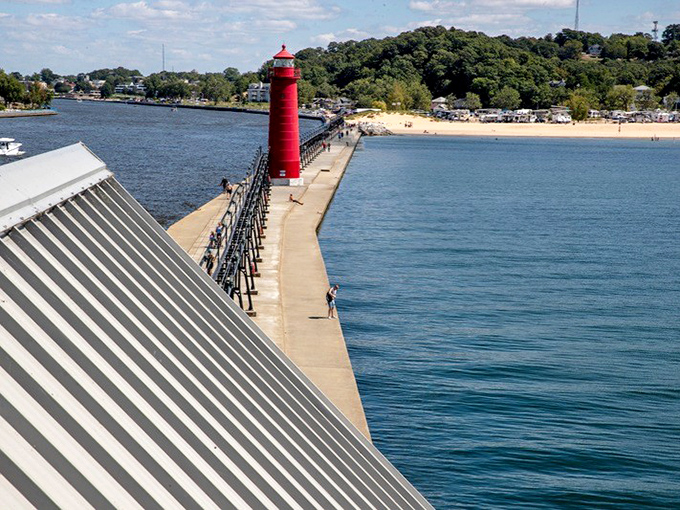 Looking down the pier's spine reveals the lighthouse's commanding position, with Lake Michigan stretching endlessly beyond.