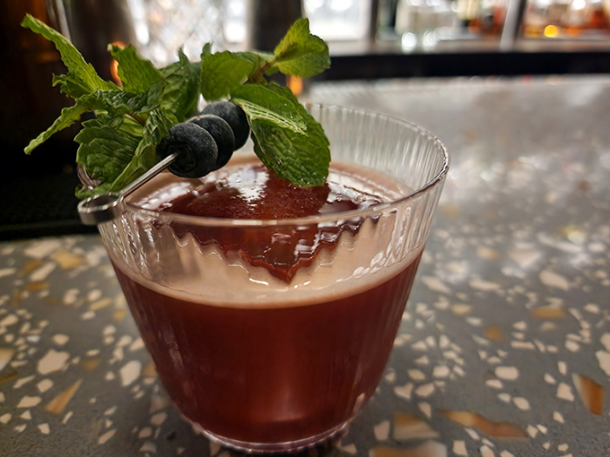An espresso martini garnished with fresh mint and berries&mdash;the perfect bridge between Coffee Down Under's two personalities.