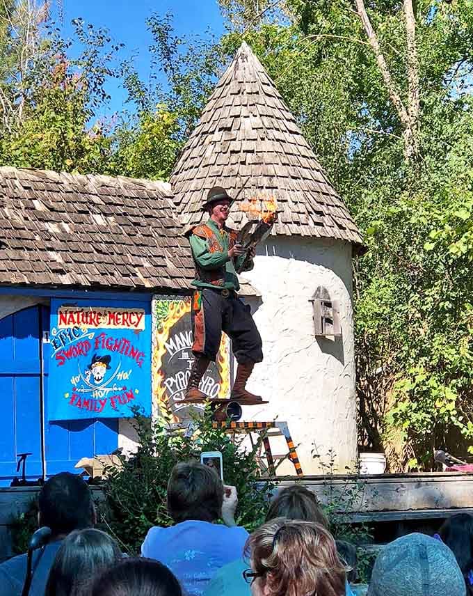 A performer demonstrates daring fire manipulation skills, combining historical entertainment traditions with modern safety practices to gasps from the crowd.