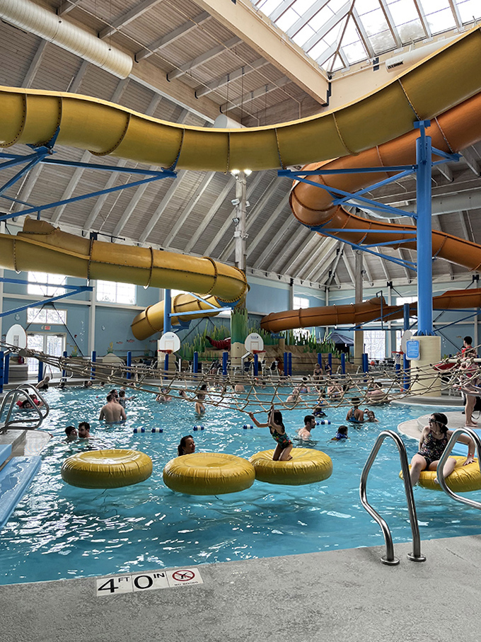 Twisting slides spiral from the ceiling while swimmers navigate the waters below &ndash; a perfect symphony of controlled aquatic chaos.