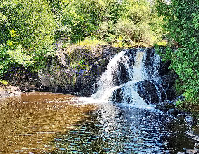 Interstate Falls cascades dramatically over ancient rock, creating a natural swimming hole that's worth every step of the hike.