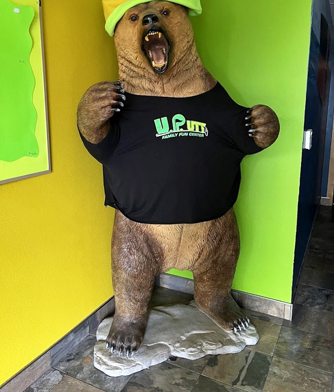 "I come with the place!" UPutt's resident bear mascot sports the company colors while greeting visitors with a toothy welcome.