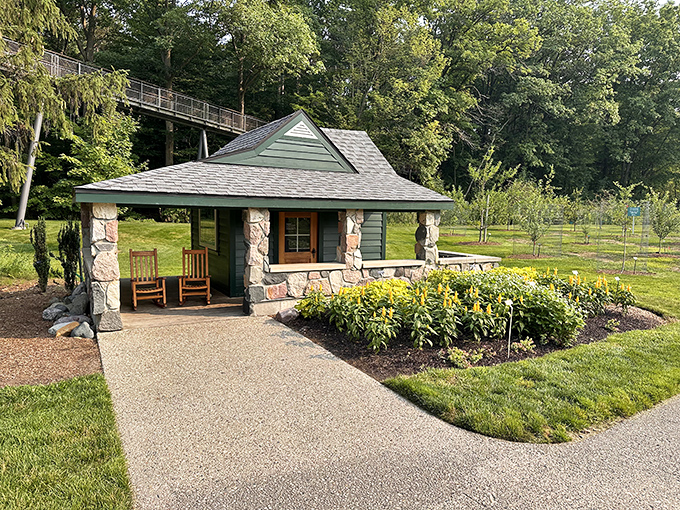 Rustic charm meets garden elegance in this stone cottage, where rocking chairs invite visitors to pause and soak in the scenery.