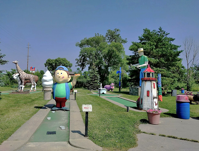 Mini-golf adventures await with whimsical obstacles &ndash; where a lighthouse, giraffe, and ice cream character create delightful challenges.