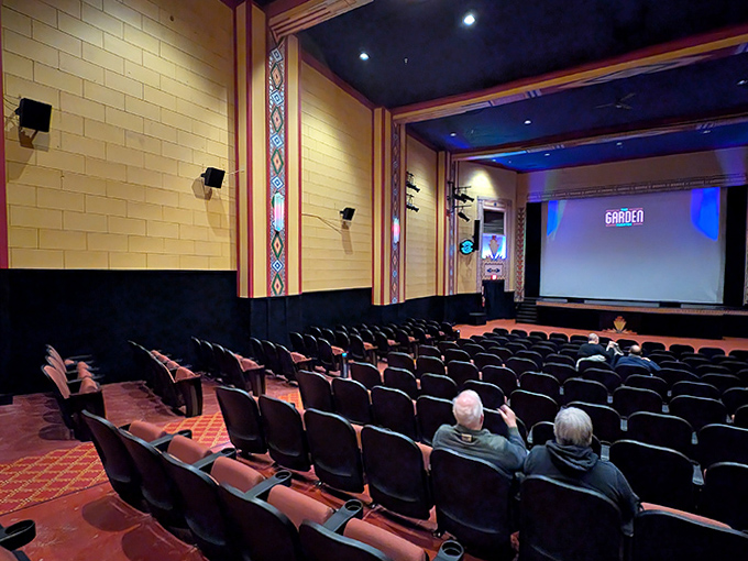 The screen awaits its moment to transport viewers, framed by original architectural details that have witnessed countless stories unfold.