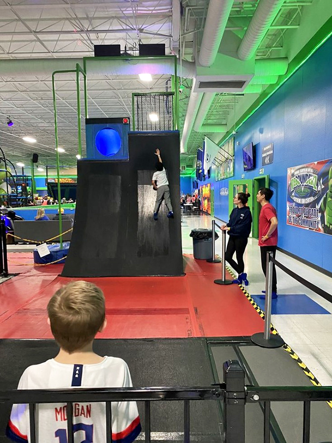 The vertical challenge wall separates the "I watch ninja shows" crowd from the "I can actually do ninja things" population with humbling efficiency.