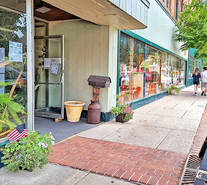 American flags and potted plants frame the entrance, creating a welcoming atmosphere that blends patriotic charm with small-town Michigan hospitality.