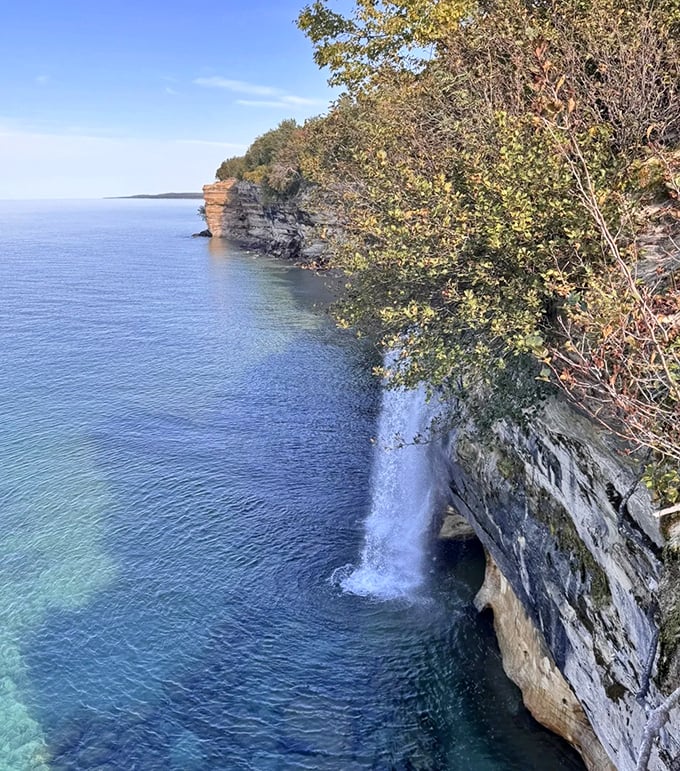 From this vantage point, Spray Falls appears as a delicate white ribbon against the rugged cliff face, a perfect contrast.