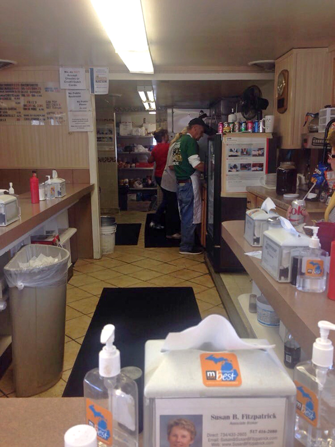 Behind the scenes in the compact kitchen where burger magic happens – decades of experience packed into every square inch.