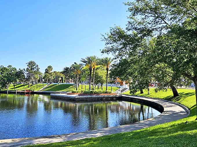 This perfectly curved pond reflects the surrounding greenery, creating a mirror world where reality seems twice as beautiful.