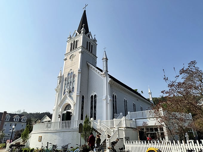 Sainte Anne's Church reaches skyward with its gleaming white steeple, a spiritual landmark that's witnessed centuries of island life through changing seasons.