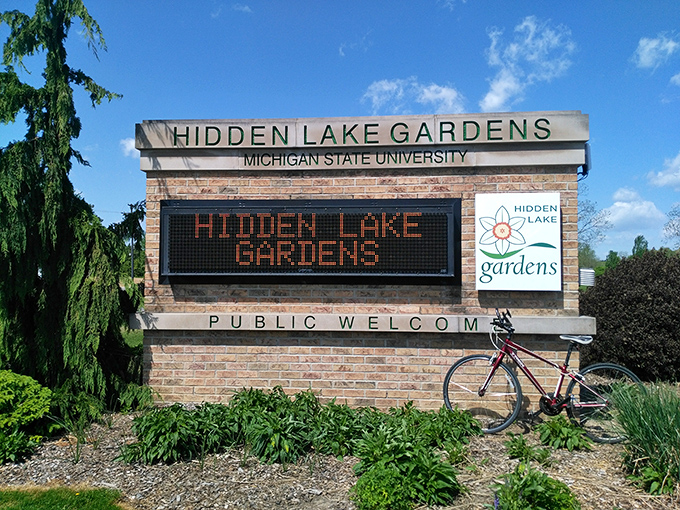 The welcoming entrance to Hidden Lake Gardens promises public access to 755 acres of botanical bliss, no green thumb required for admission.