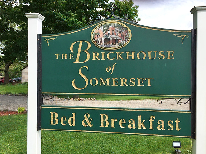 Signage: The elegant green and gold sign stands as a beacon for weary travelers, promising Victorian charm and Midwestern hospitality.