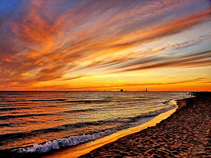Mother Nature shows off her artistic flair during sunset, painting the sky in fiery hues that reflect dramatically on Lake Michigan's surface.