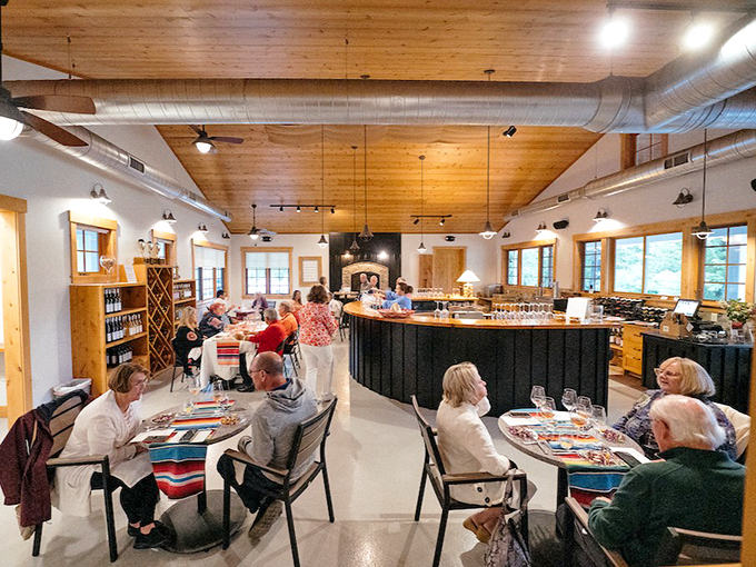 Warm wood tones and natural light create an inviting atmosphere in the tasting room, where conversations flow as freely as the wine.