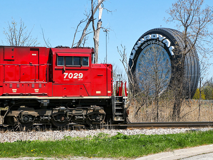 Even freight trains look diminutive next to Allen Park's rubber behemoth &ndash; a true study in transportation contrasts.