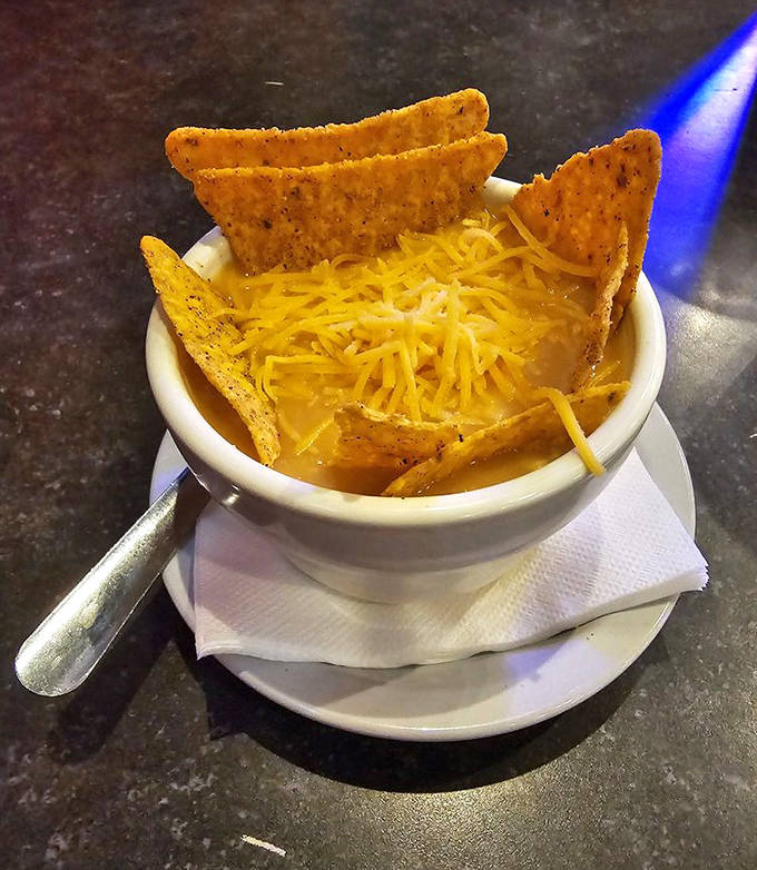 The tortilla soup &ndash; a warm, flavorful galaxy in a bowl where crispy tortilla strips, tender chicken, and fresh vegetables orbit in perfect harmony.