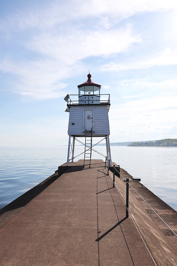 Two Harbors lighthouse stands sentinel at the harbor entrance, its crisp white structure a reassuring beacon for generations of grateful Lake Superior mariners.