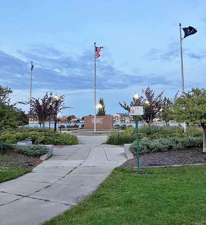 Veterans Memorial Park's flags stand at attention against Michigan skies &ndash; a peaceful tribute space where community and remembrance blend seamlessly.