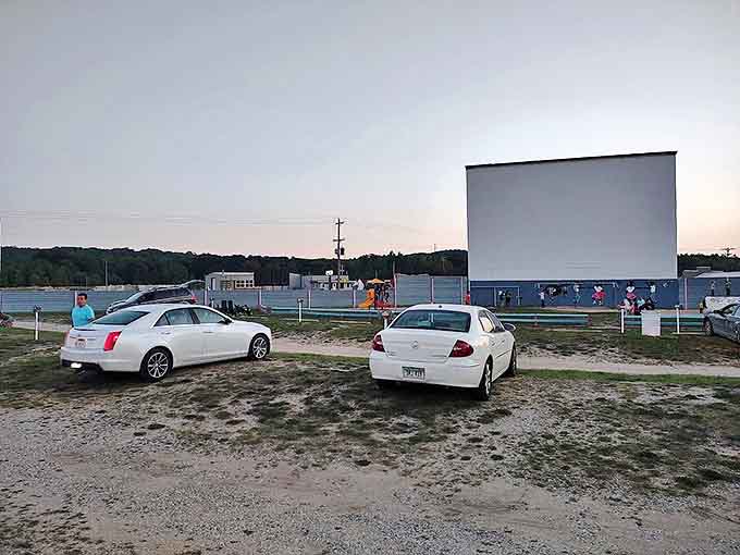 Vehicles point toward cinematic adventure as twilight approaches. Some arrive hours early for prime spots and pre-show socializing.