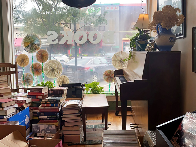 A cozy reading nook complete with piano invites passersby to imagine themselves lost in a good book while the world rushes by.