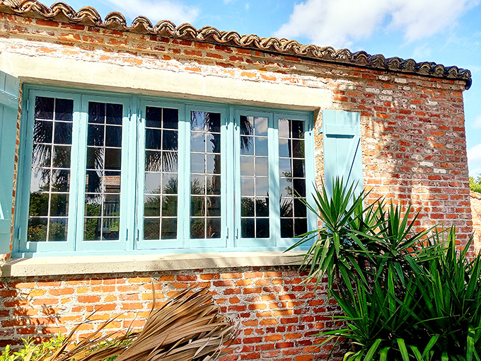 Windows framed in weathered brick and painted shutters prove that sometimes the best views are the ones looking out from historic spaces.