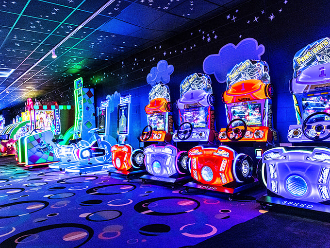 The arcade glows with neon promise, where kids trade tokens for tickets and parents trade sanity for five minutes of peace.