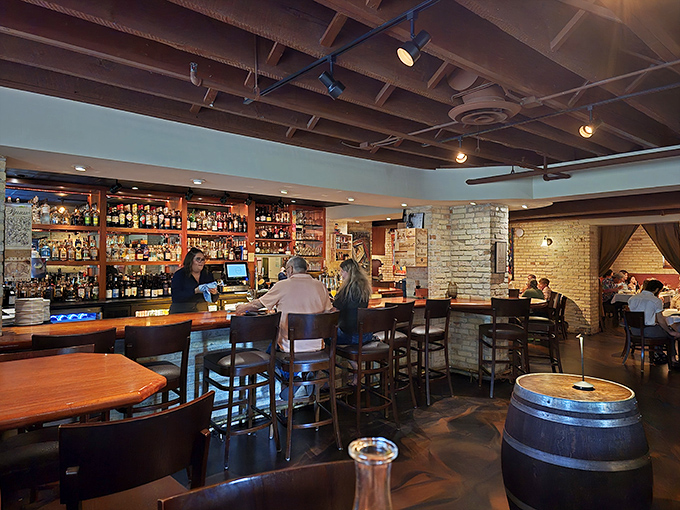 The bar beckons with amber-lit bottles promising Italian-inspired libations crafted with precision and flair.