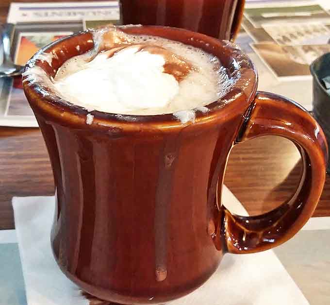 Coffee served in sturdy mugs with that distinctive diner taste – the perfect companion to cut through donut sweetness.