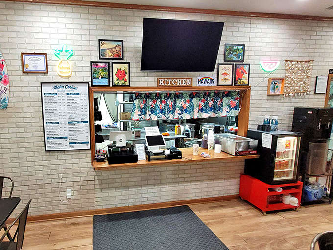 The counter and kitchen area where Hawaiian magic happens, complete with tropical curtains that probably make the cooks feel like they're on vacation.